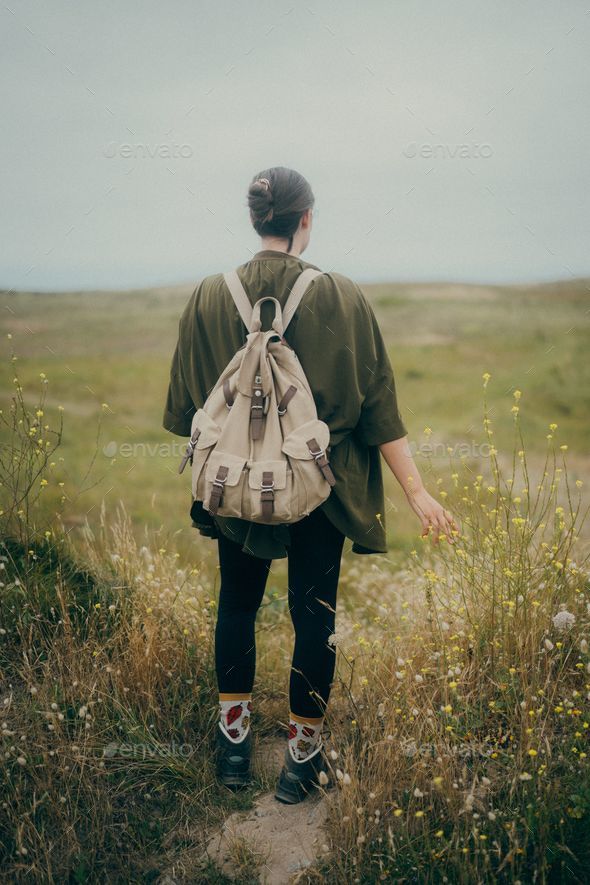 Female hiker trekking in the wilderness with a fully loaded backpack ...