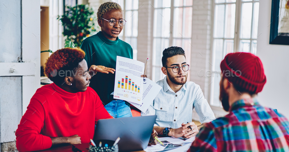 multicultural people collaborating on infographic startup project ...