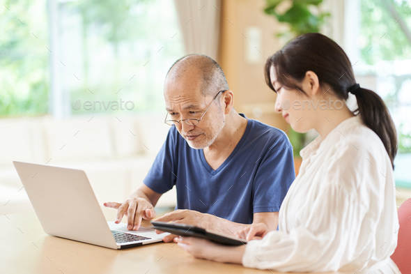 Elderly people who are taught how to use a computer at a long-term care ...