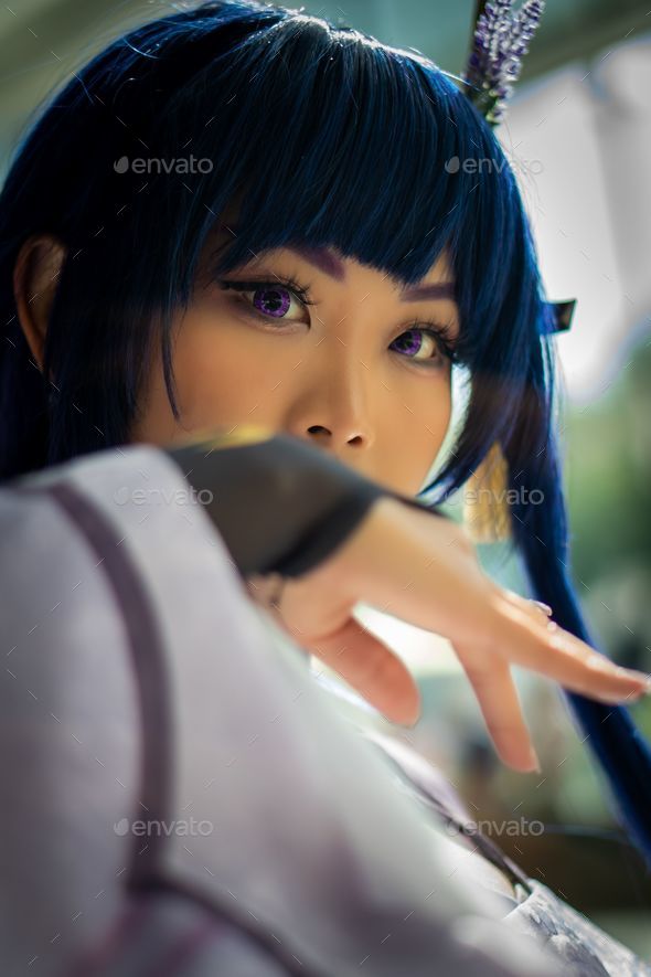 Closeup of a Southeast Asian young female with blue hair and ...