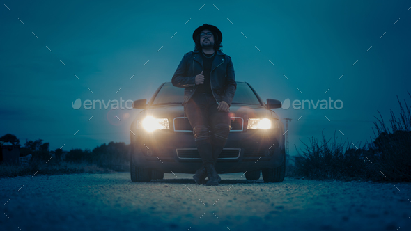 Cinematic scene of a car with a man in a hat and jacket Stock Photo by ...