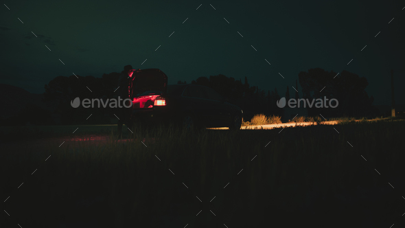 Cinematic scene of a man opening the trunk of a car at night. Interior ...