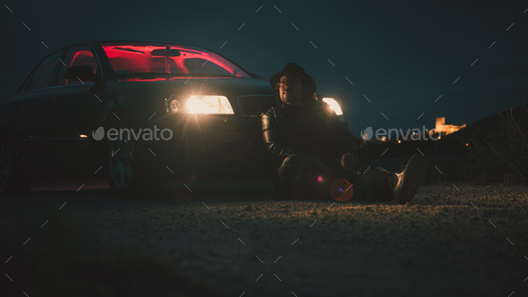 Cinematic scene of a car with a man in a hat and jacket. Interior ...