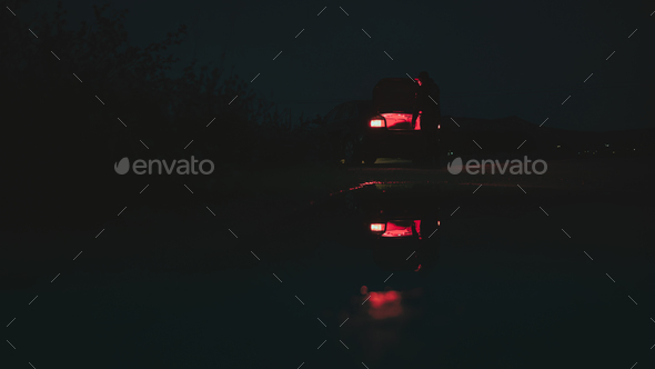 Cinematic scene of a man opening the trunk of a car at night. Interior ...