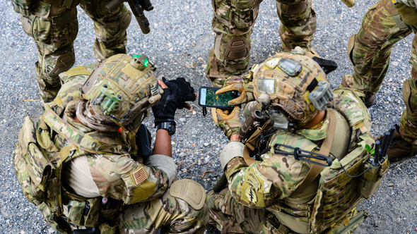 Smart teamwork of soldiers running forward and attacking enemy during ...