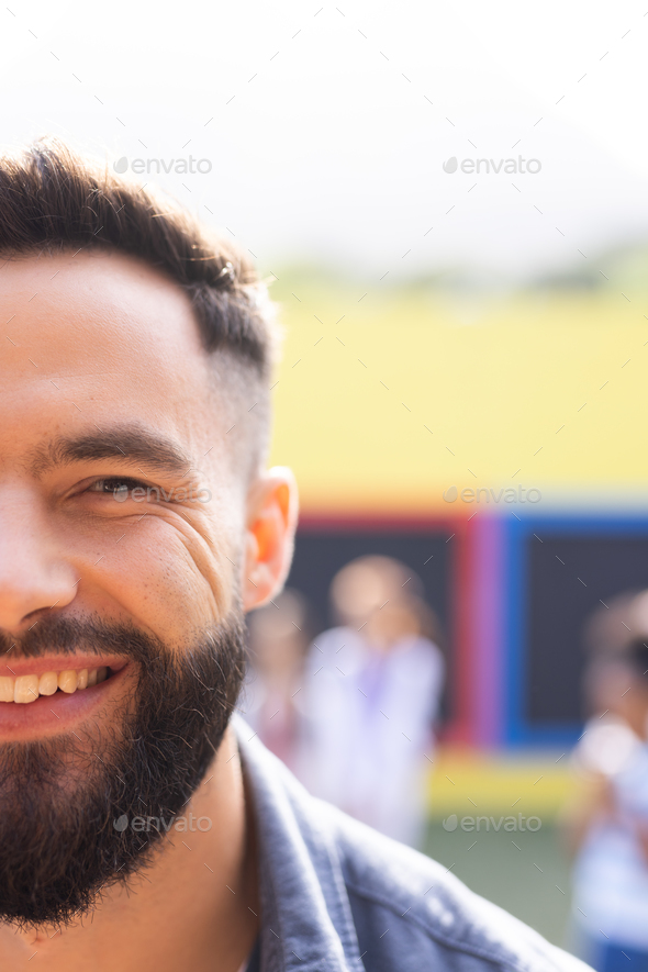 Vertical half face portrait of smiling, bearded caucasian male school ...