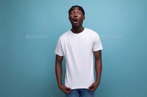 a dark-skinned European young man with dreadlocks is dressed in a white ...