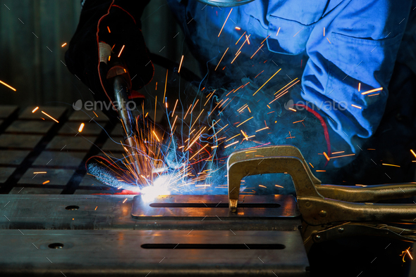 Skilled welder carries out various welding works using semi-automatic ...