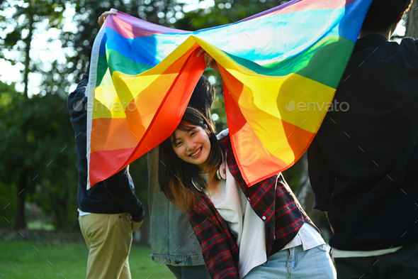 Group of young activist with pride rainbow flag, love symbol of LGBT ...