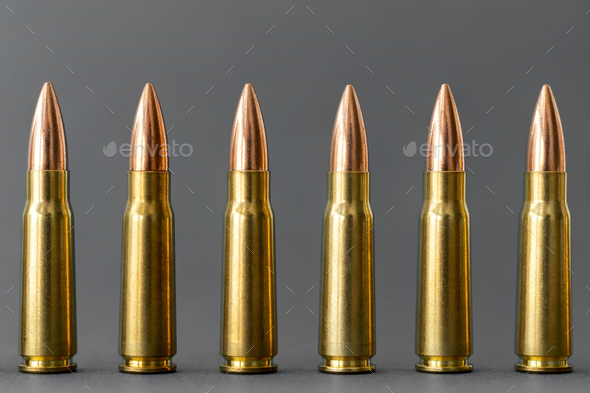 Bullets on gray background. Cartridges 7.62 caliber for Kalashnikov ...