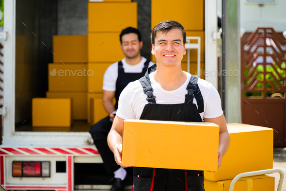 Happy two delivery men in front of delivery truck, Delivery men ...