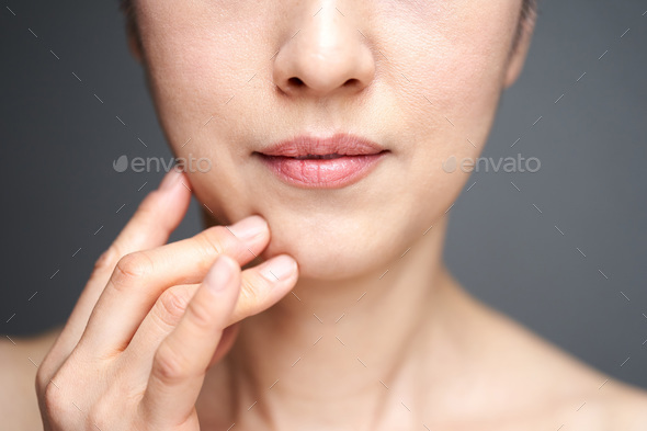 Middle-aged Japanese woman worried about wearing a cheek stick Stock ...
