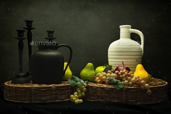 Stunning still-life shot depicting an arrangement of jugs, grapes, and ...