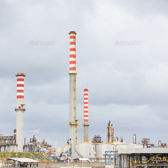Oil refinery industry, smoke stacks on cloudy sky background Stock ...