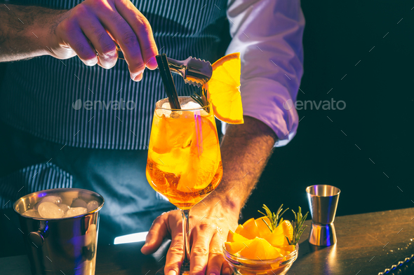 Bartender decorating Aperol Spritz cocktail glass Stock Photo by ...
