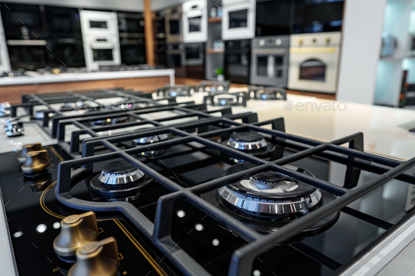Modern cooking stoves on display in the store Stock Photo by FabrikaPhoto