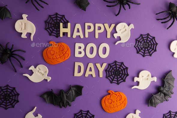 Happy Boo Day lettering on purple background with halloween decor ...