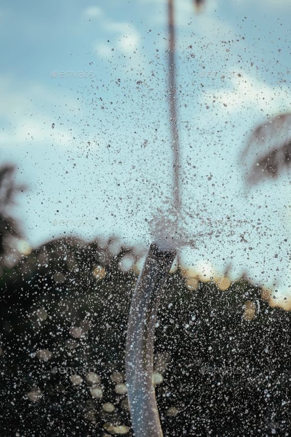 Stream of water splashing from a pipe, creating a dramatic effect with ...