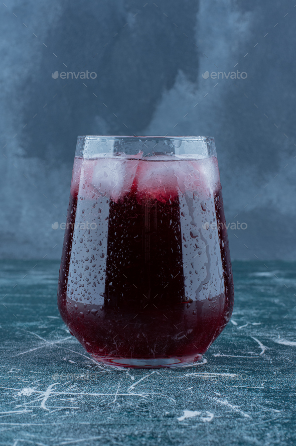 A glass of processed juice on the blue background Stock Photo by 13people