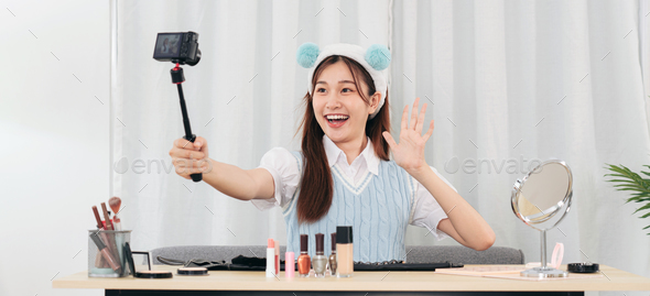 Beautiful influencer woman is hold camera to greeting in video ...