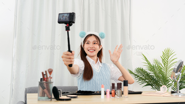 Beautiful influencer woman is hold camera to greeting in video ...