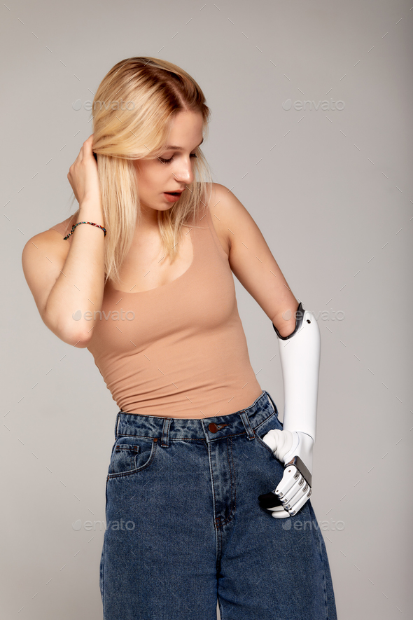 Studio half-length portrait of beautiful young blonde girl with ...