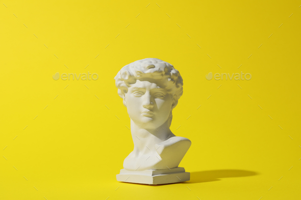 Plaster statue of the head of David on a yellow background Stock Photo ...