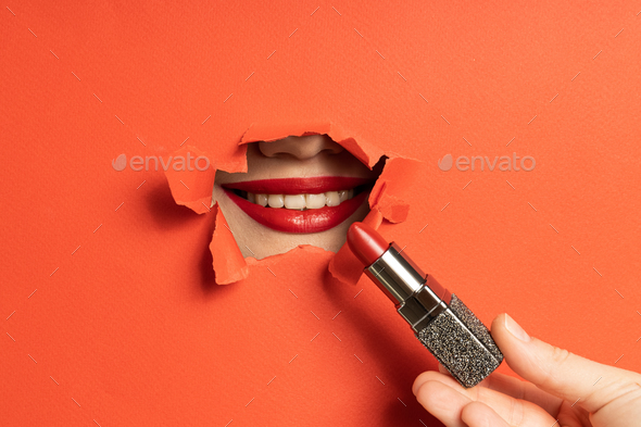 Close-up of female lips in torn paper hole with lipstick Stock Photo by ...