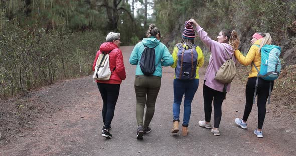 Multi generational women walking outdoor having fun during trekking day ...