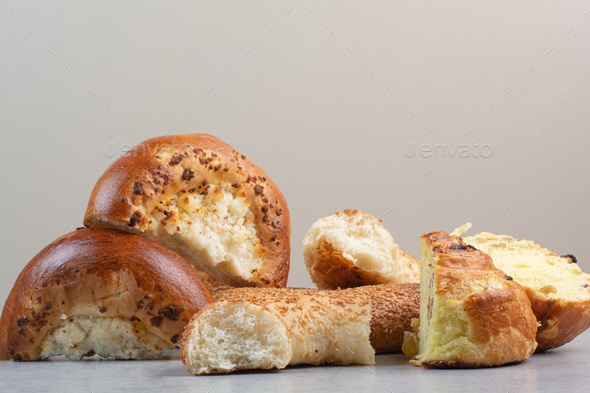 Half cut raisin buns and sesame bagels on beige background Stock Photo ...