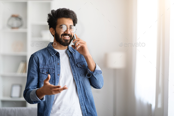 Portrait Of Smiling Handsome Indian Man Talking On Cellphone At Home ...