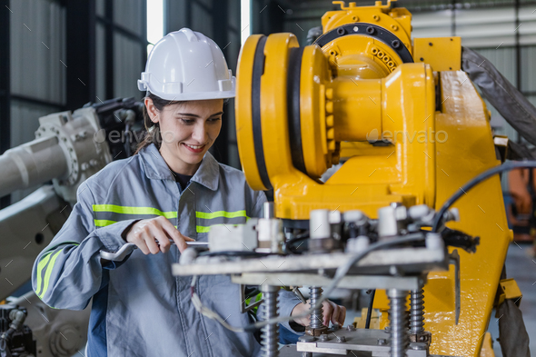 Engineers woman using wrench maintenance robotic arm. Female technician ...