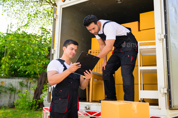 Happy two delivery men in front of delivery truck, Delivery men ...