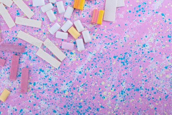 Different types of chewing gums arranged into messy lines on a colorful ...