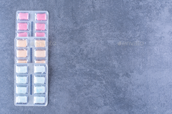 Line-up of chewing gum table packs with various flavors on marble ...