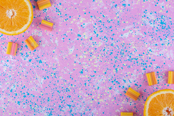 Oppositely aligned orange slices surrounded with bubblegums on a ...