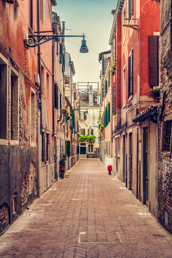 Vintage old Italian street in Venice, Italy Stock Photo by photocreo