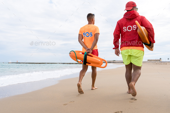 Rear view of two lifeguards on the beach Stock Photo by riderfoot ...