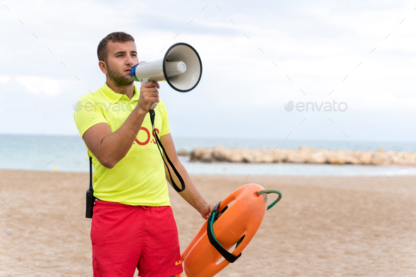 Lifeguard using a megaphone on the beach Stock Photo by riderfoot ...