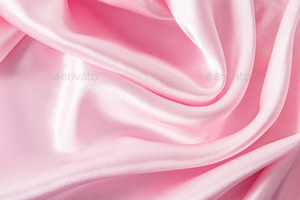 Elegant satin fabric with a pink color. The luxurious texture of the ...