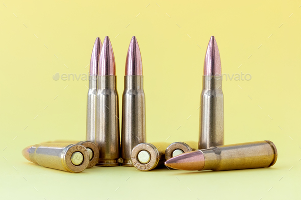 Bullets on yellow background. Cartridges 7.62 caliber for Kalashnikov ...