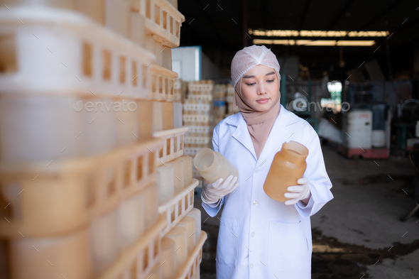 Portrait of a young scientist working in a laboratory She is examining ...