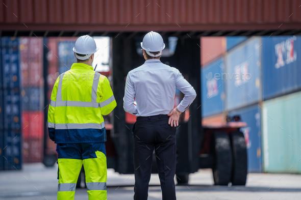Engineer container cargo with worker checking stock into container for ...