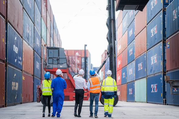 Manager and professional container yard workers checking stock for ...
