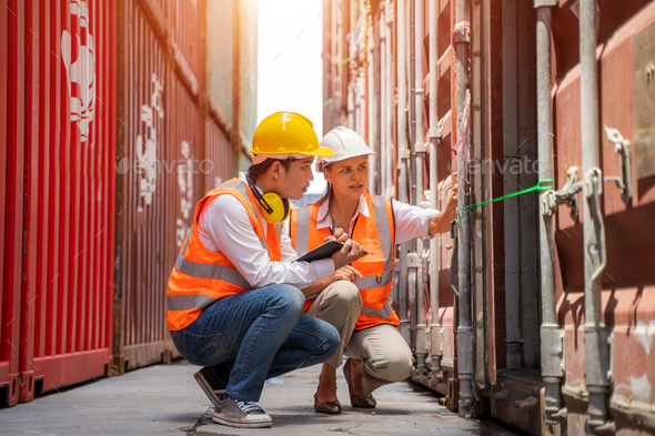 Engineer working and checking a quality of containers box from cargo ...