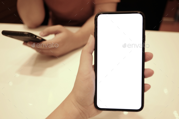 Women's hands holding cell telephone watching social media in a smart ...