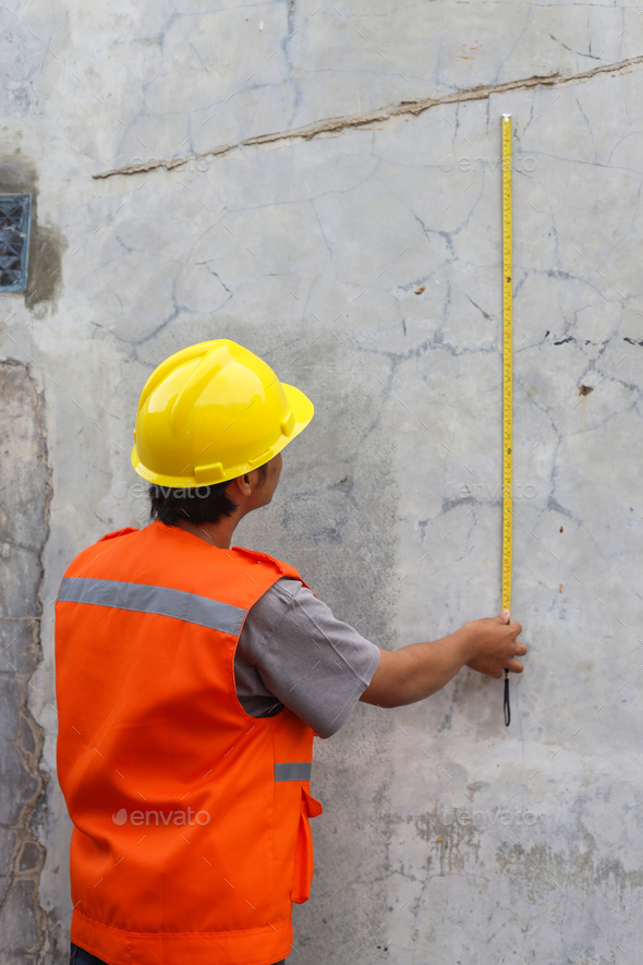 Construction worker measure and calculate construction site. Stock ...