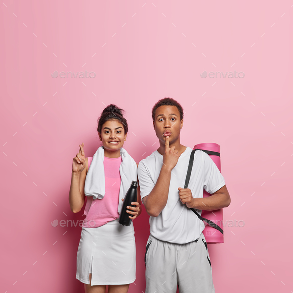 Pair of young fit happy smiling broadly European female and surprised ...