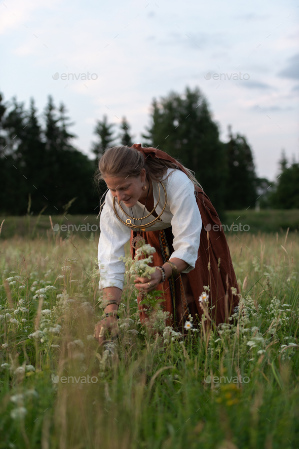 Midsummer celebration countryside- woman wearing national costume ...