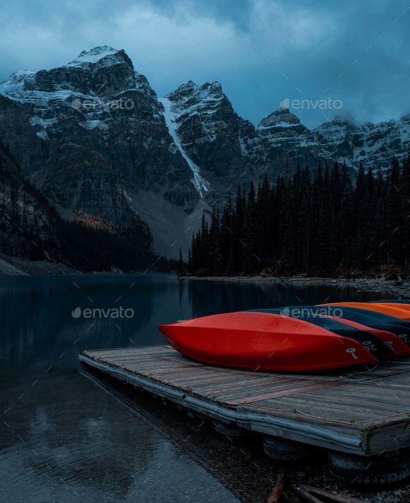 Dock of boats on a tranquil mountain lake Stock Photo by wirestock